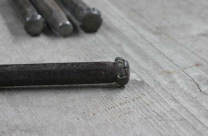 Maintaining stone carving chisels by grinding off the mushroomed heads